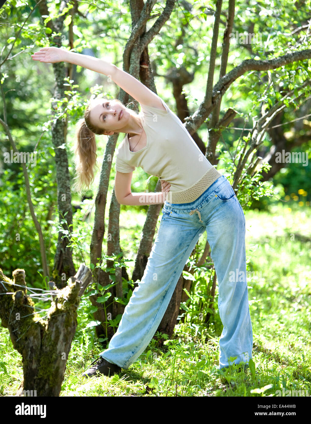 slender woman does sporting training in park Stock Photo - Alamy