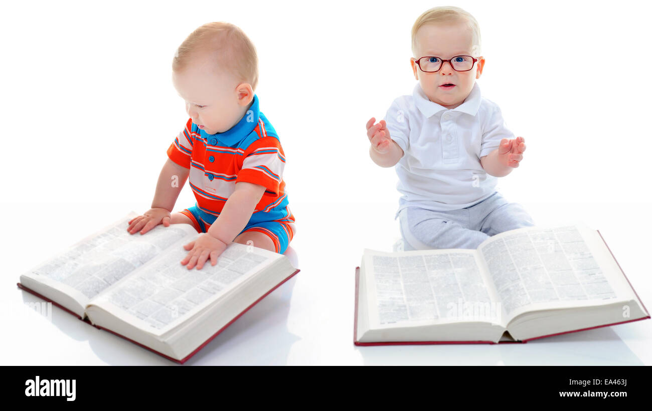 Little smart boy reads a big book Stock Photo - Alamy