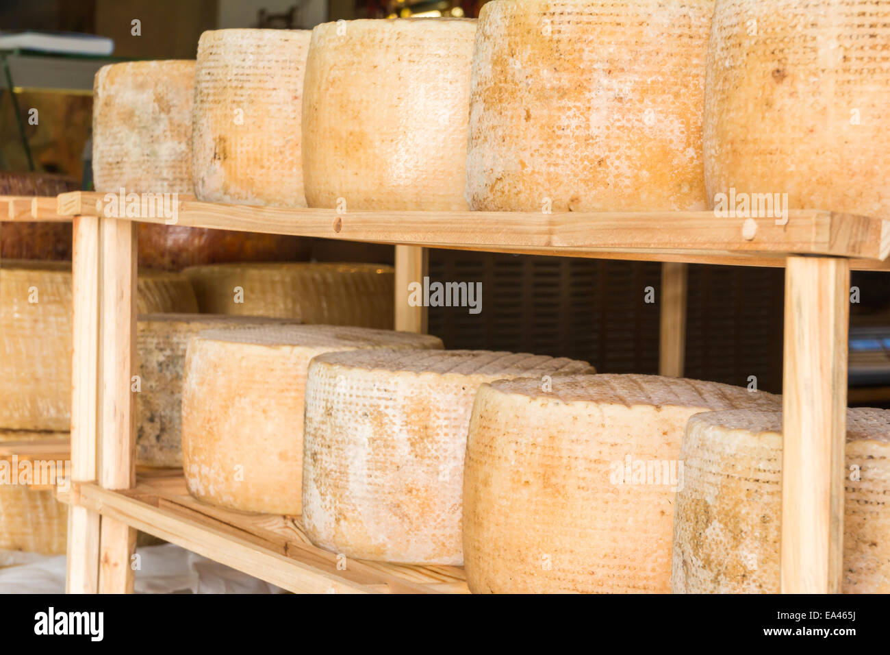series of round forms of aged cheese for sale in the local market Stock ...