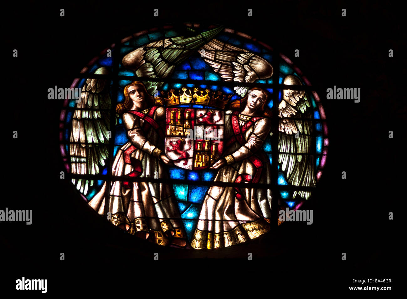 A stained glass window showing two angels holding the coat of arms of ...