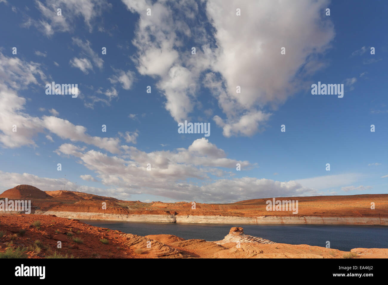 Red stone desert and the bright blue water Stock Photo - Alamy