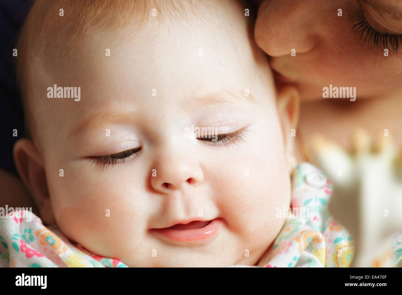 Mom and baby faces Stock Photo - Alamy