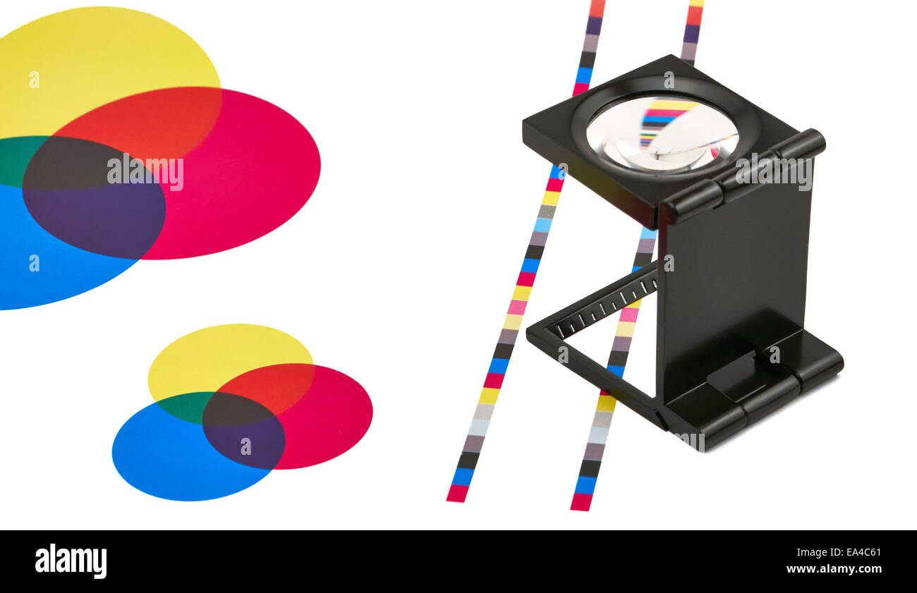 Magnifying glass standing on printing control color guide on white ...