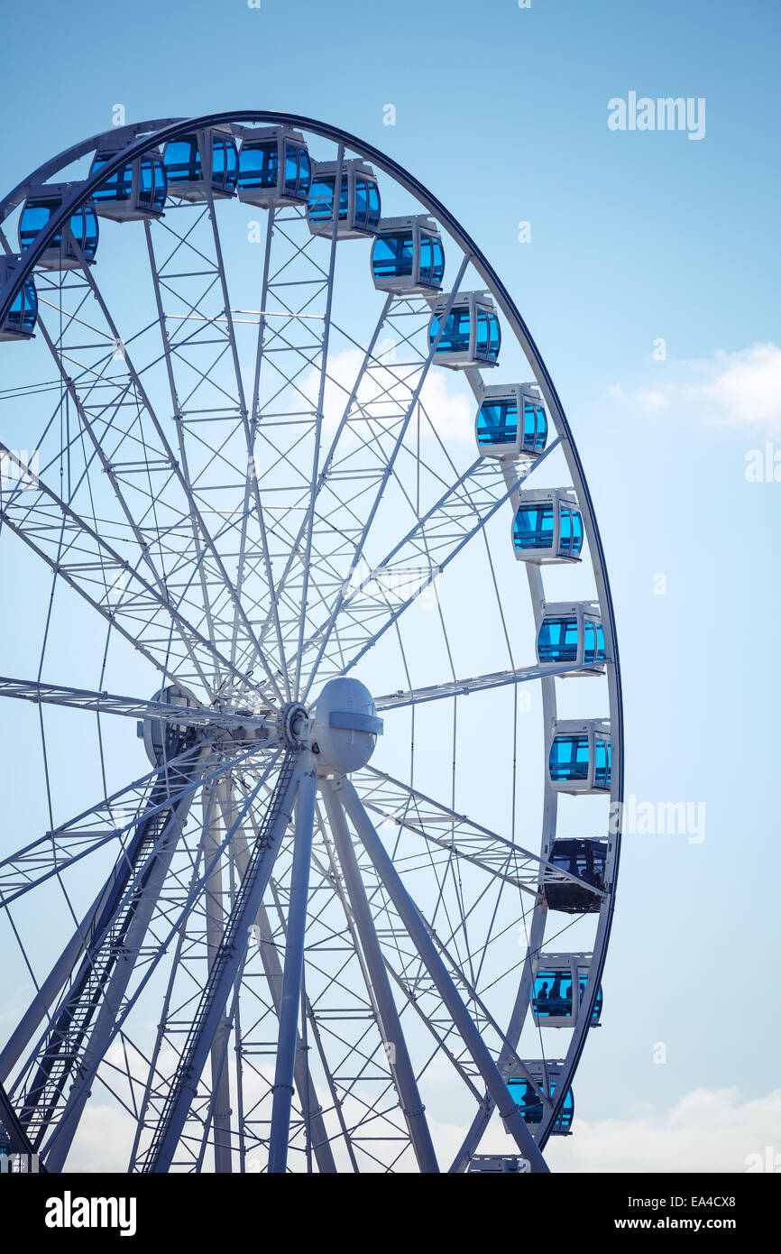 Ferris wheel above blue sky background. Vertical photo Stock Photo - Alamy
