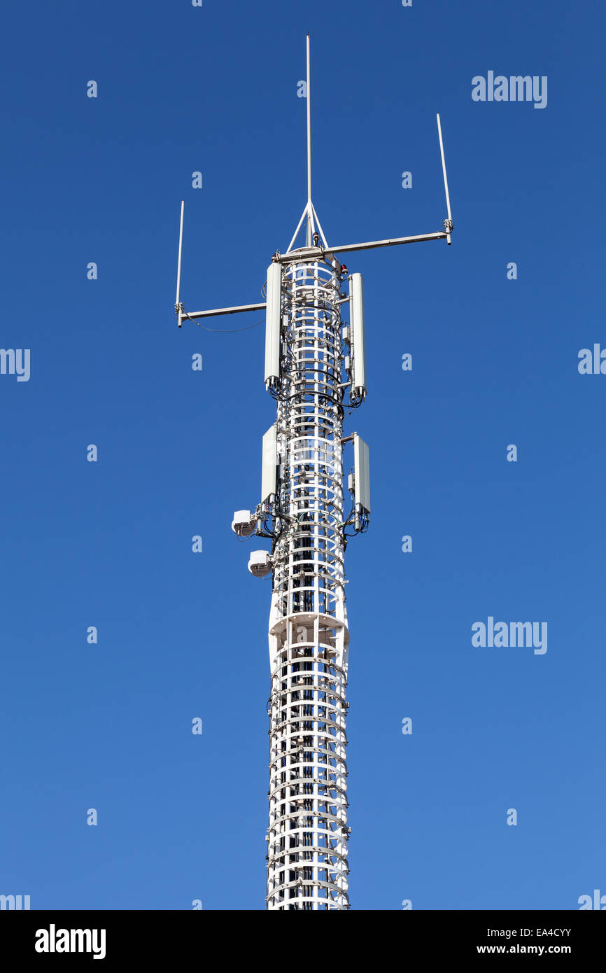 Communication tower with GSM and radio devices above blue sky Stock Photo - Alamy
