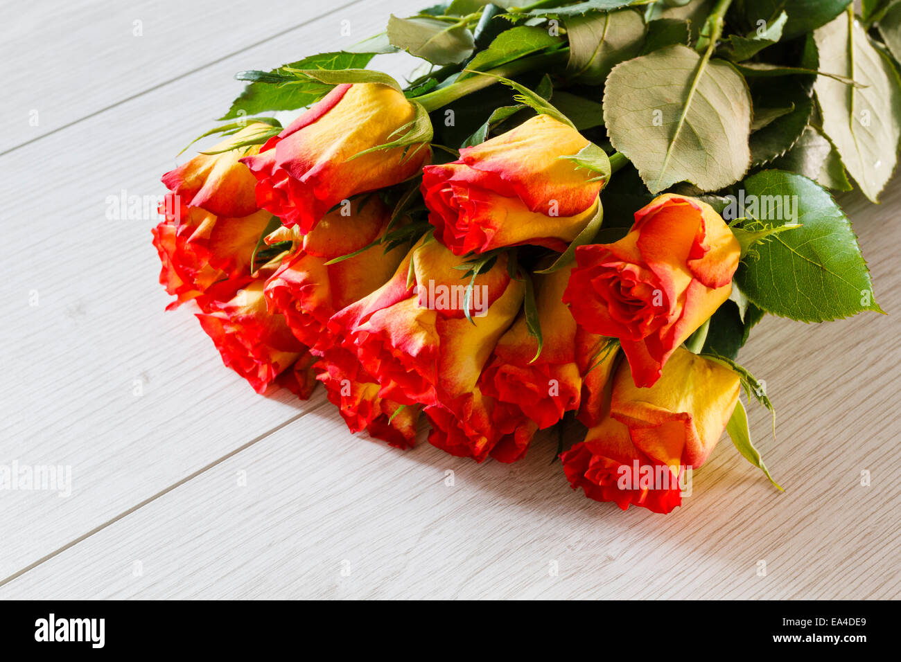 Bunch of red and yellow roses on a table top Stock Photo - Alamy