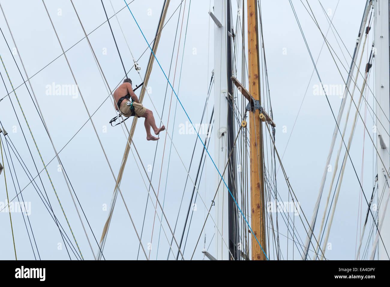 Sailor climbing yacht mast Stock Photo - Alamy