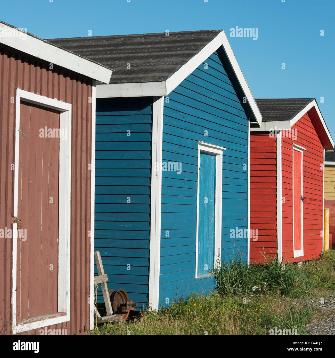 Sheds in various colours in a row; Trout River, Newfoundland, Canada ...