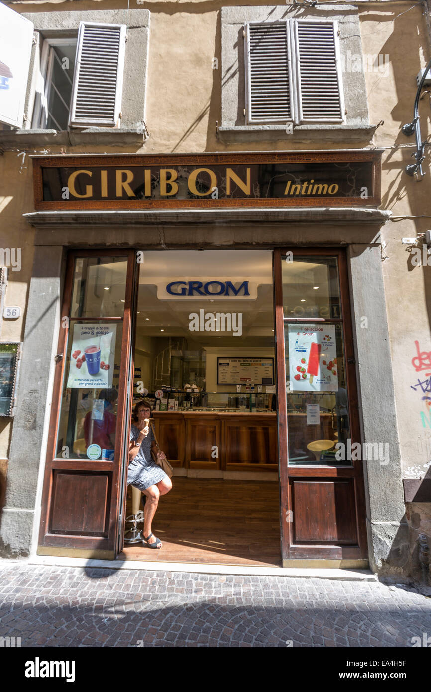 Woman enjoying a Grom ice cream Stock Photo - Alamy