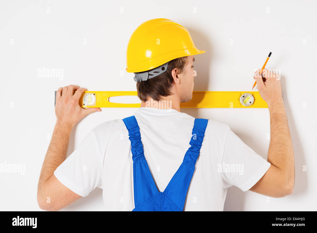 Repairman measuring with builder level Stock Photo - Alamy