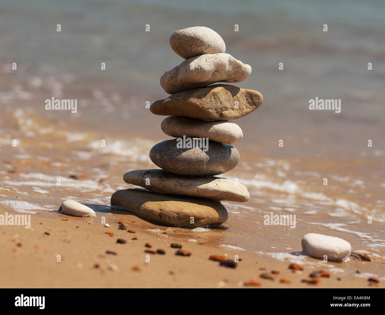 A tower build of small stones on a beach (color image] Stock Photo - Alamy