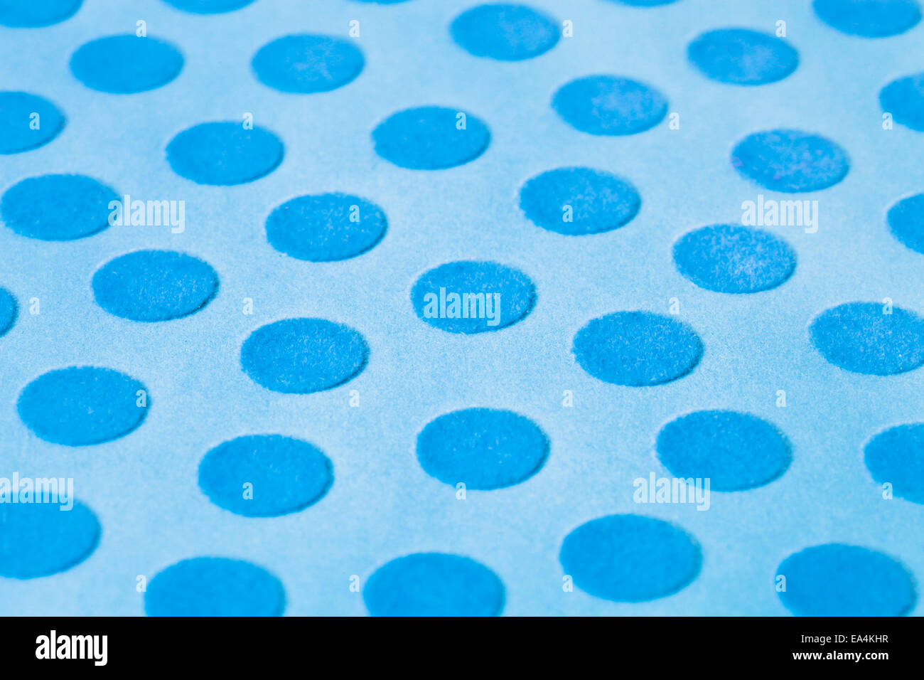 Blue velvet dots on paper as a background, with shallow depth of field ...