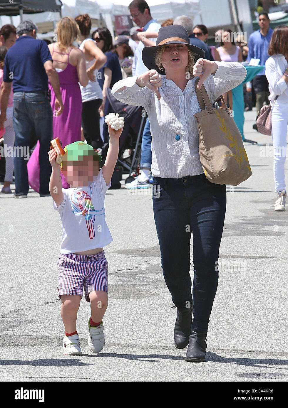 Comedienne Amy Poehler gives a thumbs down gesture while at the farmers ...