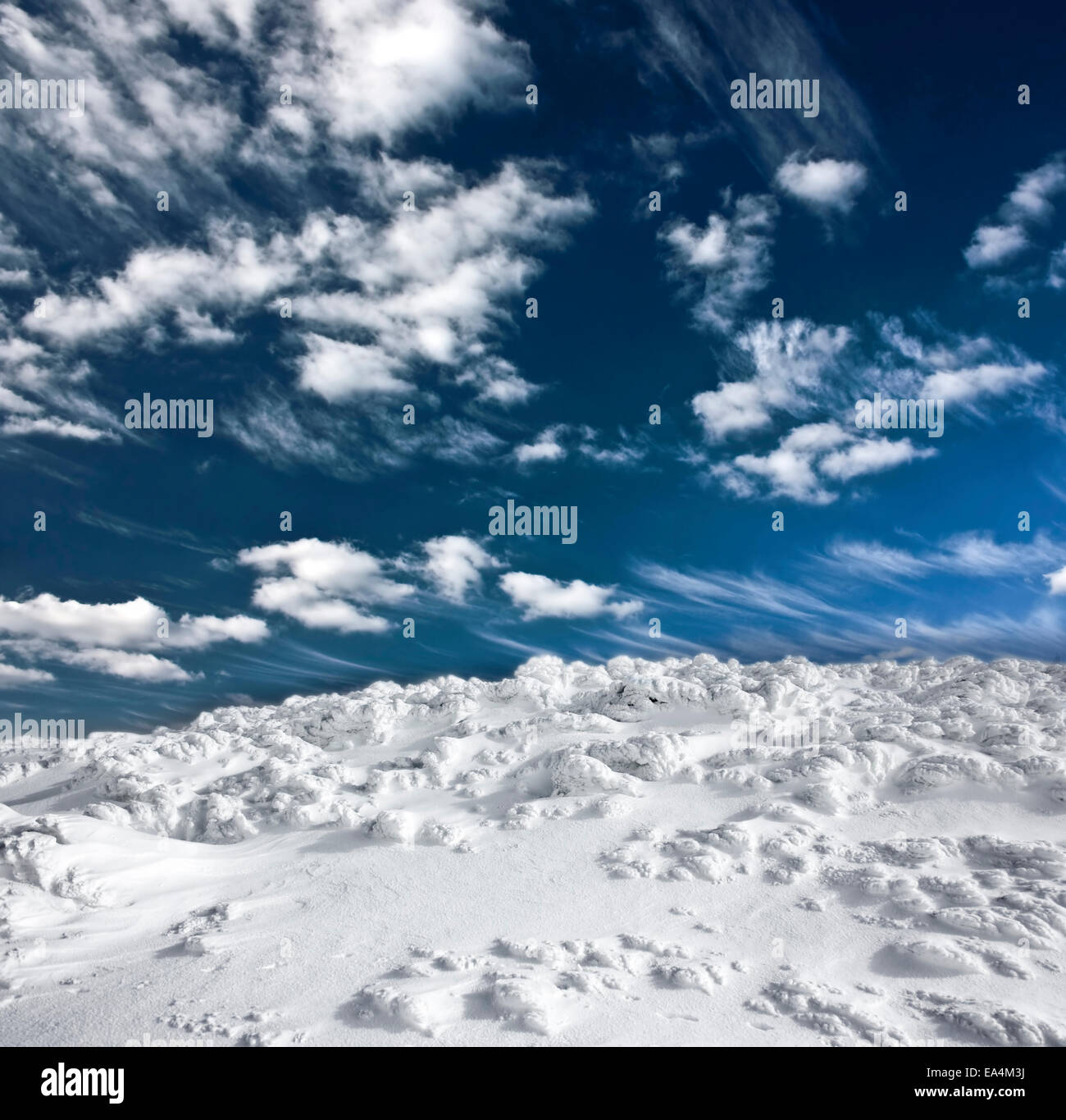 Winter landscape with snow covered hill and cloudy blue sky Stock Photo ...