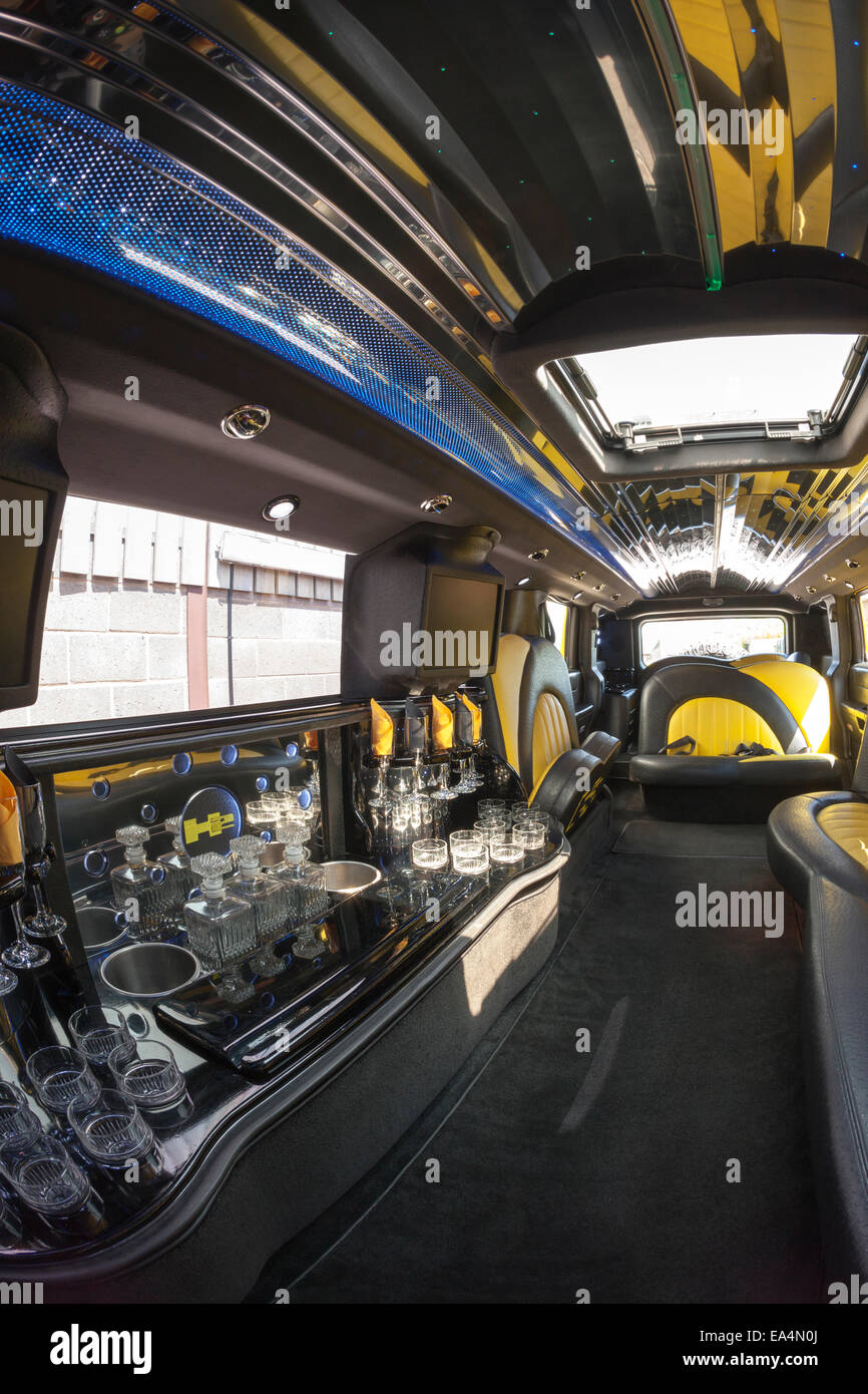 The interior of a luxury limousine with black and yellow leather seats ...