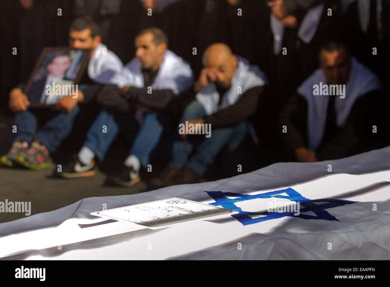 Jerusalem. 6th Nov, 2014. Friends and relatives mourn near the coffin ...