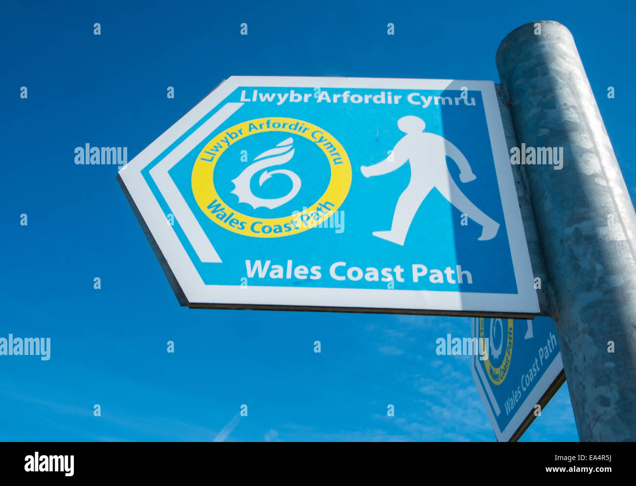 Wales Coast Path signpost in two languages,Welsh and English, at the ...
