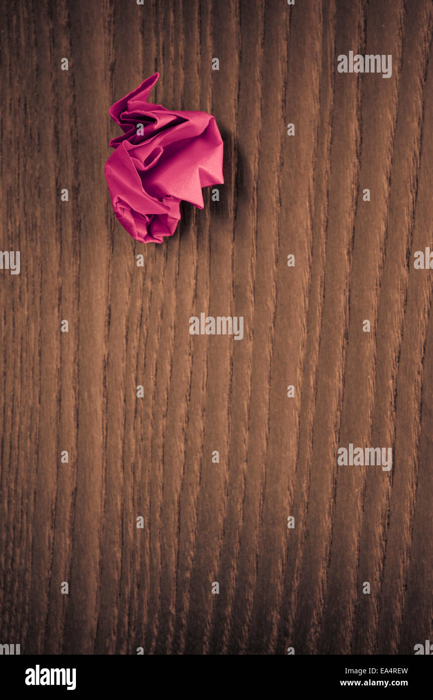 balled up recycled paper on a wood surface Stock Photo - Alamy