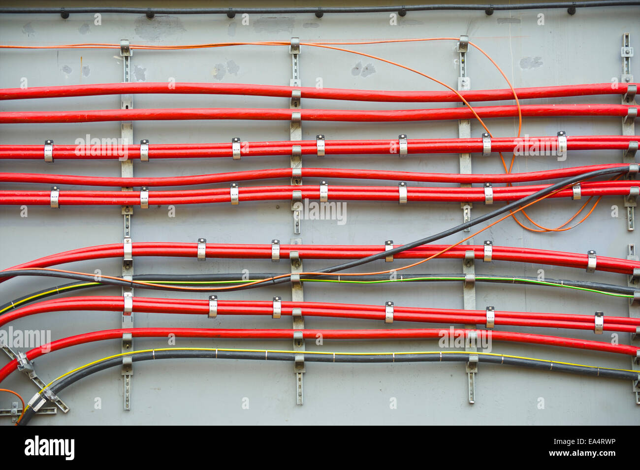 Cables lining a wall; London, England Stock Photo - Alamy