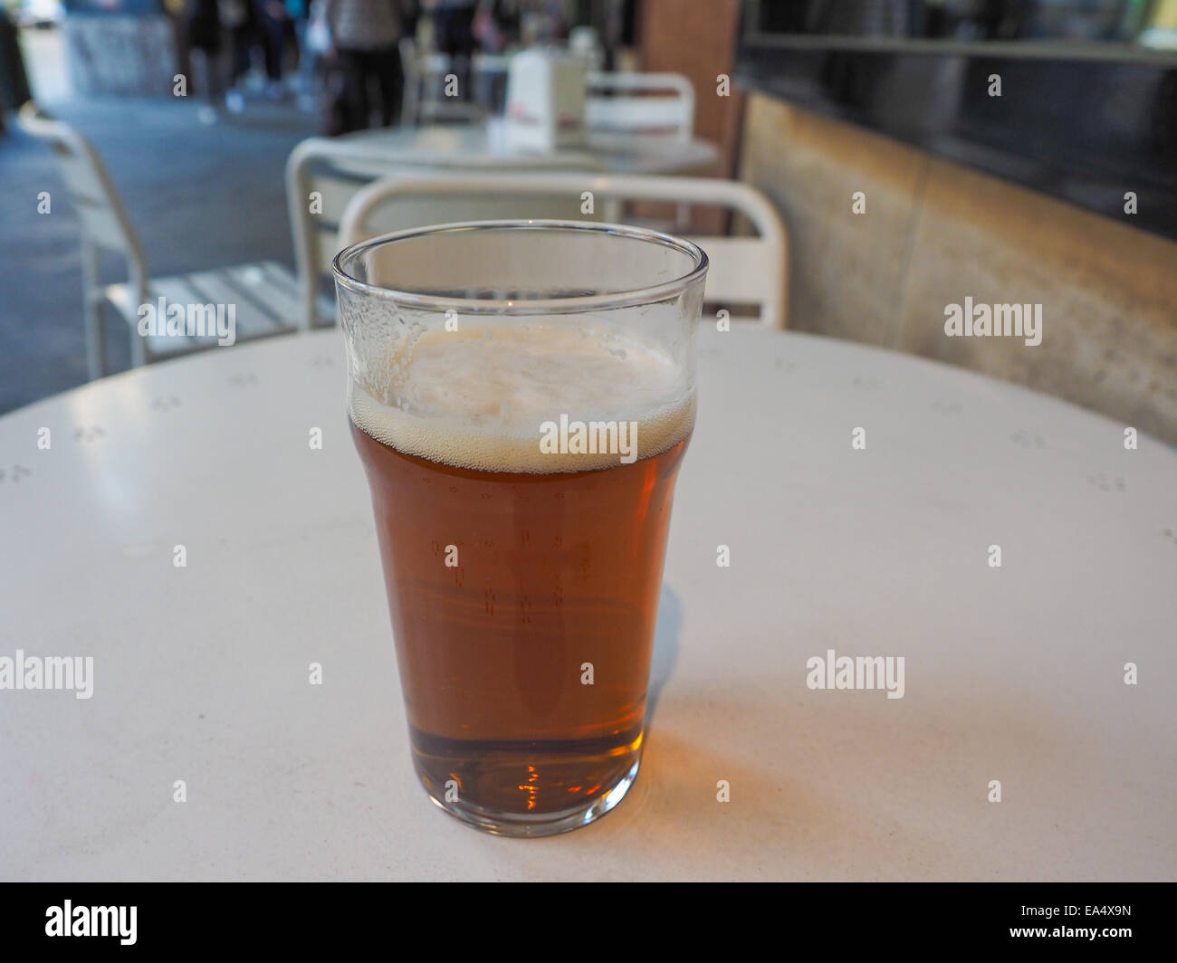 Pint of British ale on a pub table - selective focus on beer over ...