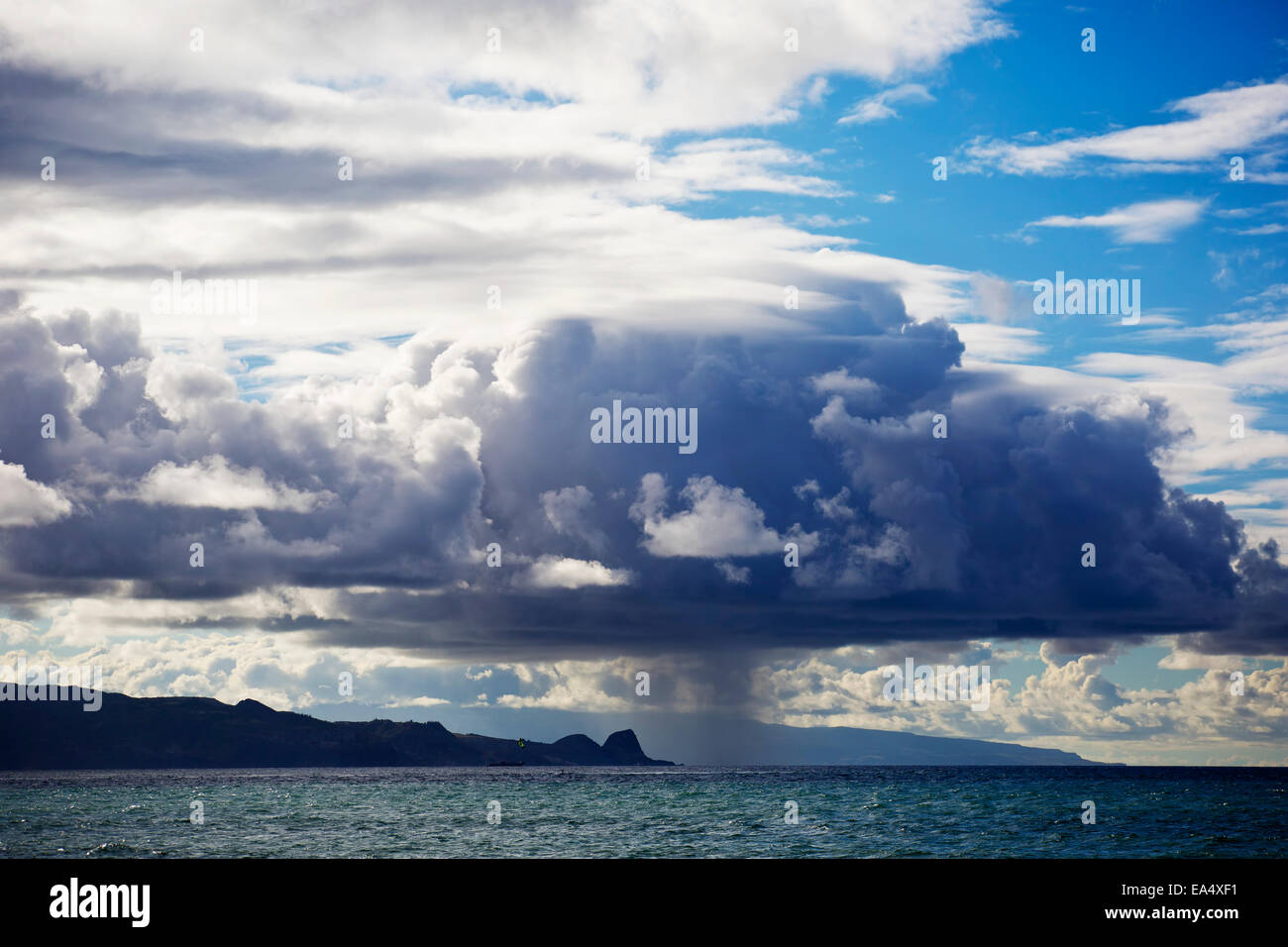 Rain cloud dumping water over the north shore of Maui; Maui, Hawaii ...