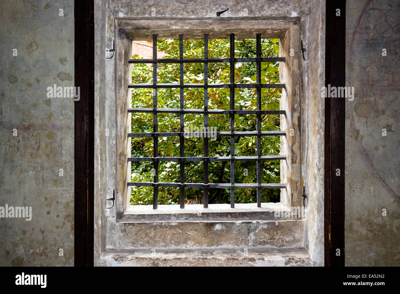 Medieval window with iron grating in Prague. Ancient stone walls ...