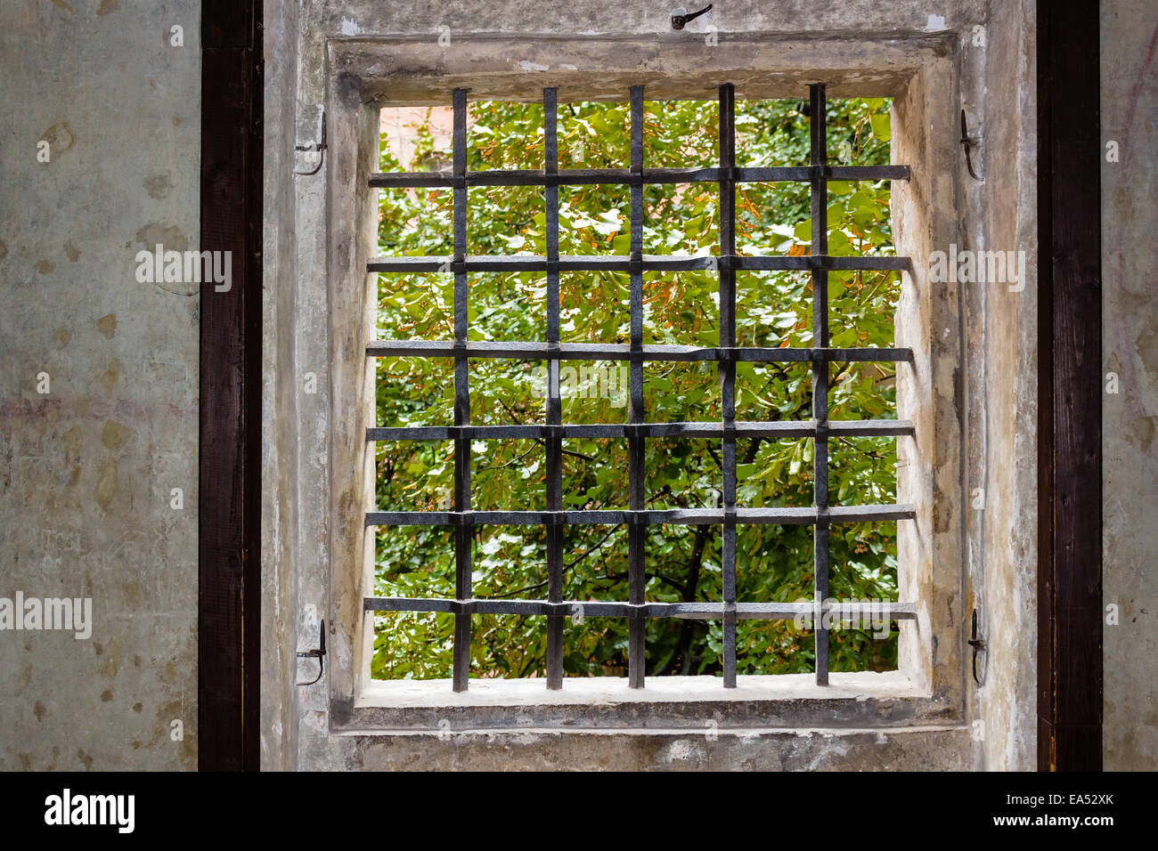Medieval window with iron grating in Prague. Ancient stone walls ...