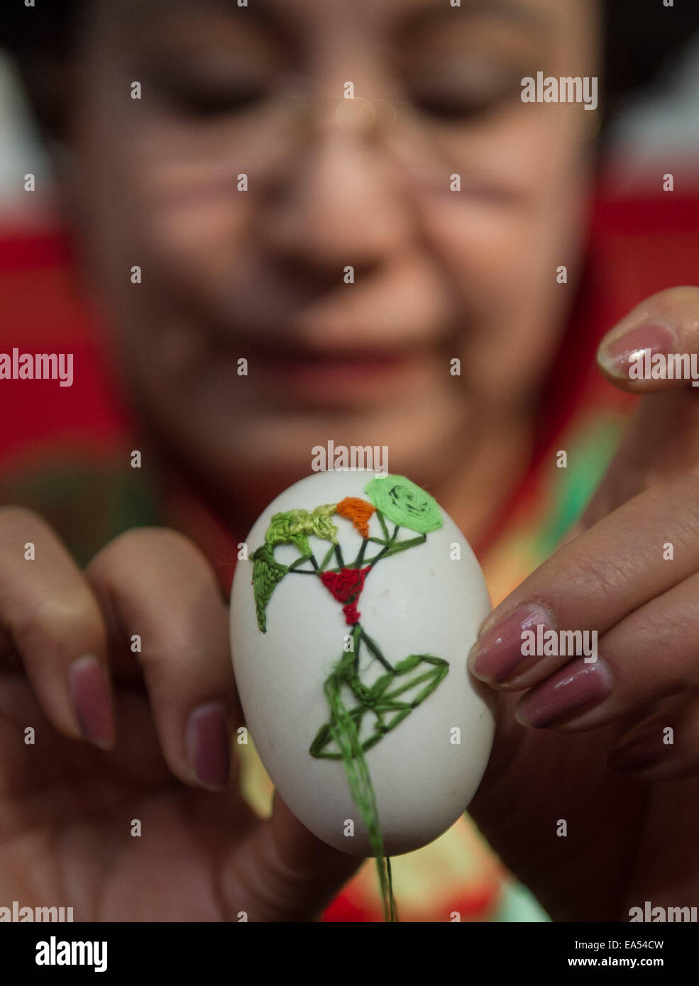 Beijing, China. 7th Nov, 2014. A folk artist demonstrates the making of ...