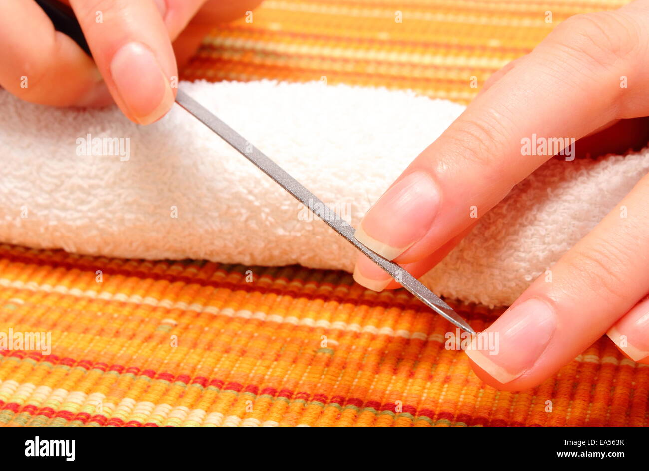 Woman with file filing nails, woman polishing nails, manicure, nail ...