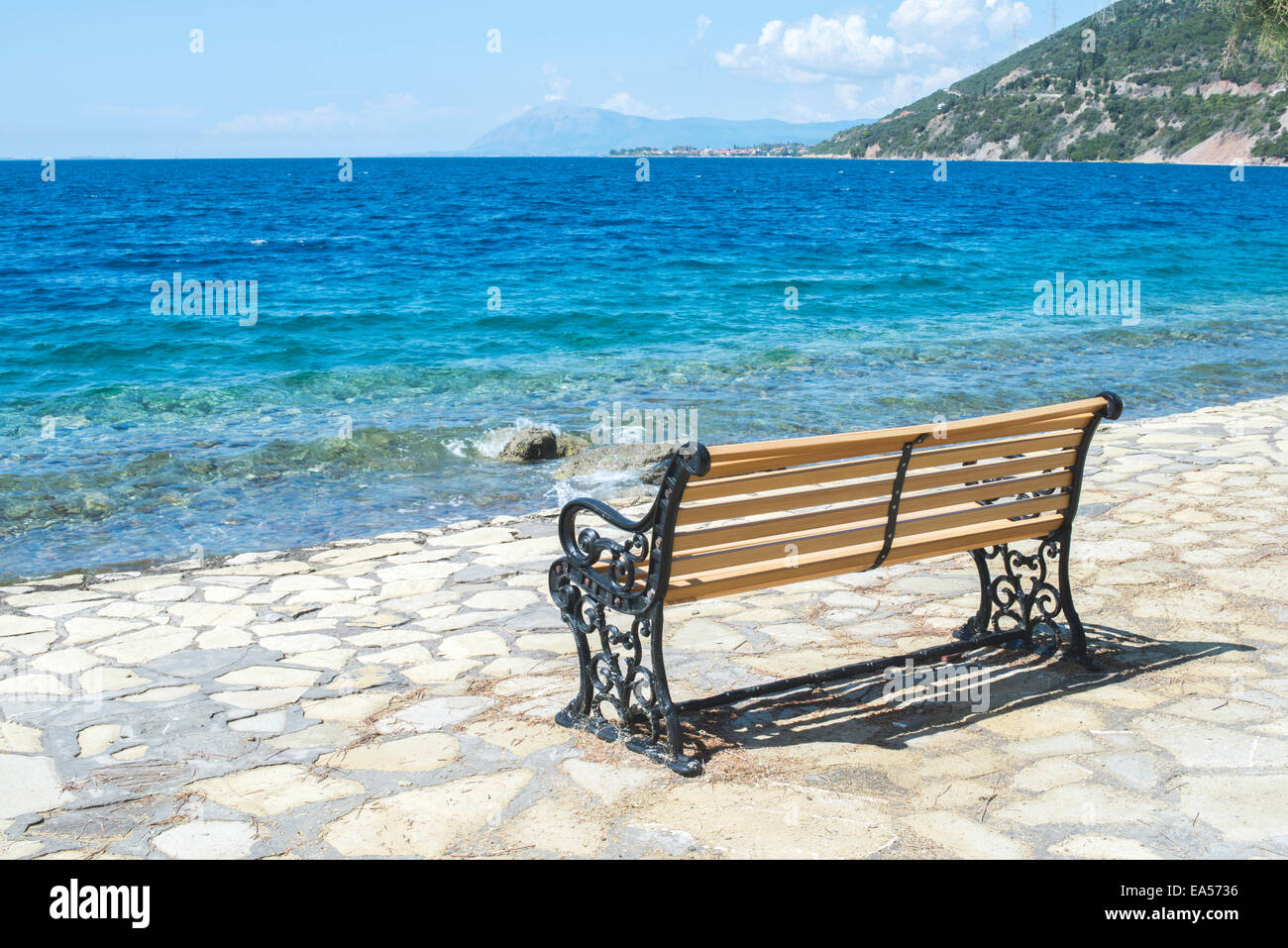Bench on the beach. Blue sky Stock Photo - Alamy