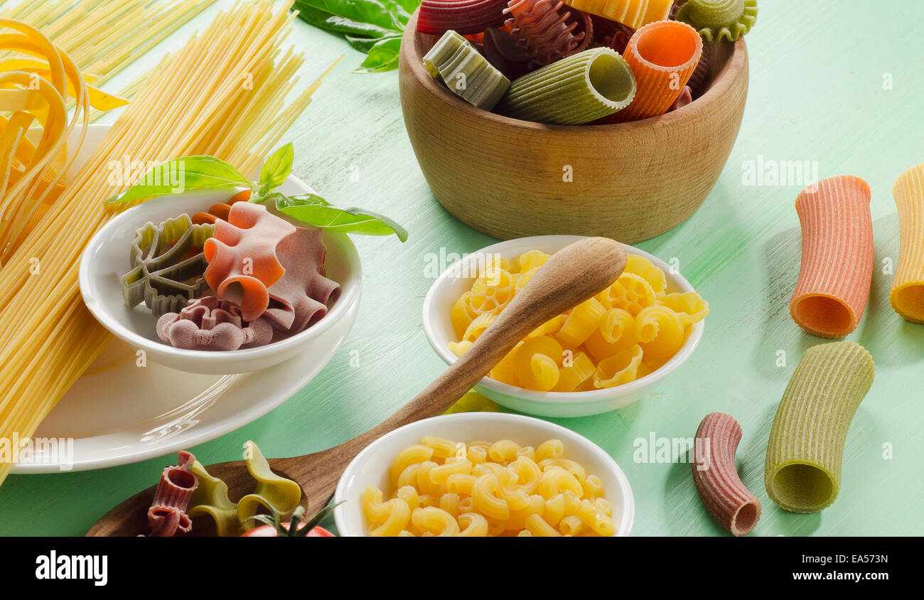 Different types of pasta on a wooden table Stock Photo - Alamy