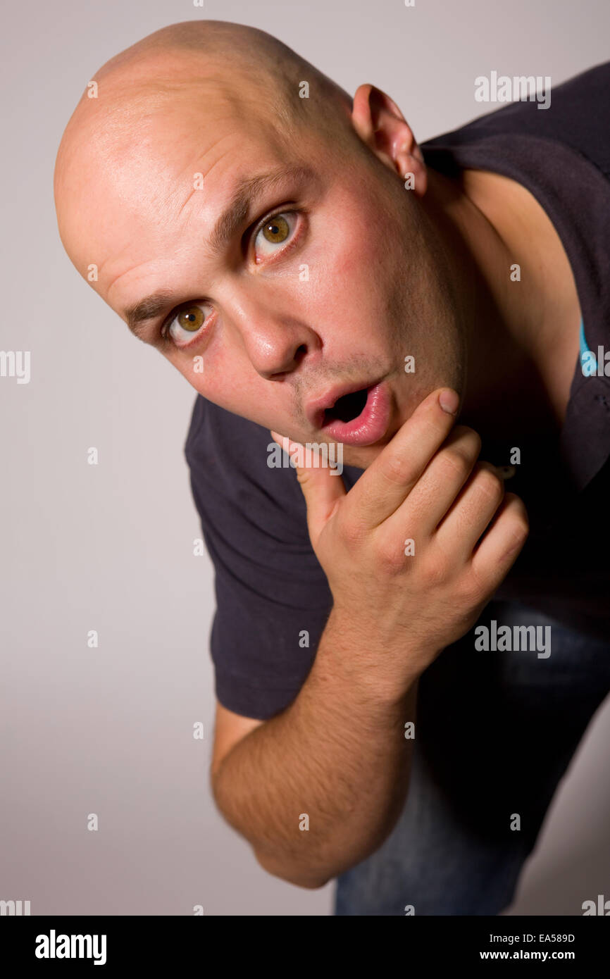 Portrait of young silly man on a dark background Stock Photo - Alamy