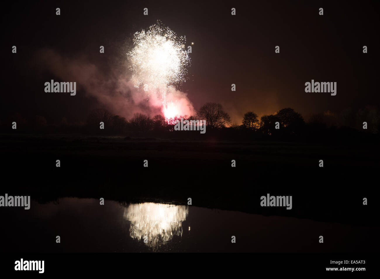 Lewes Bonfire night. A firework display is reflected in the River Ouse ...