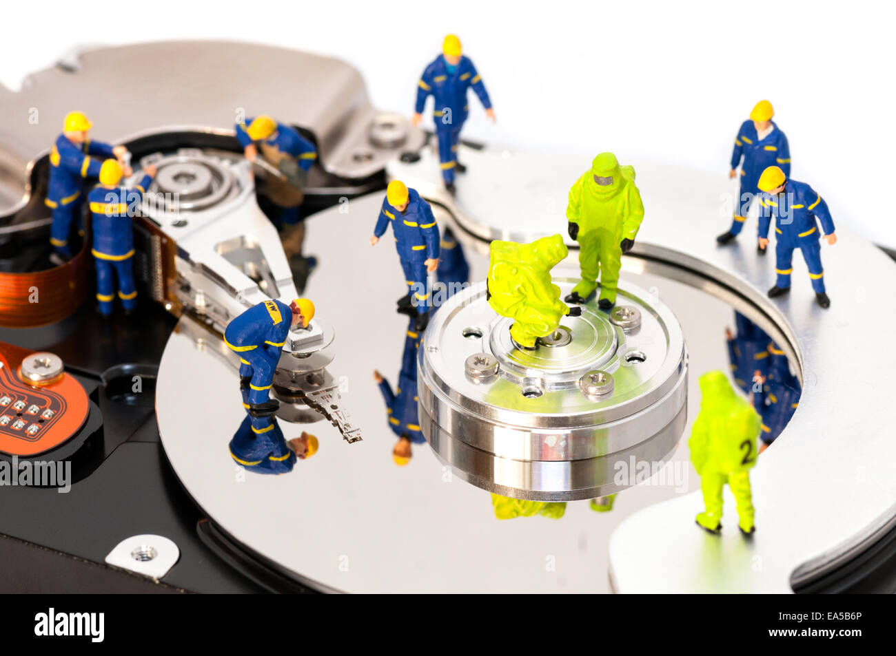 Group of engineers maintaining hard drive. Computer repair concept ...