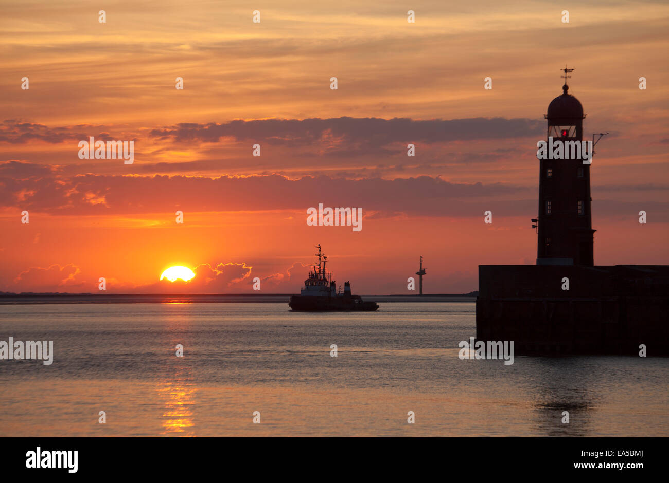 Germany, Bremen, Bremerhaven, Lighthouse on the pier at sunset Stock ...