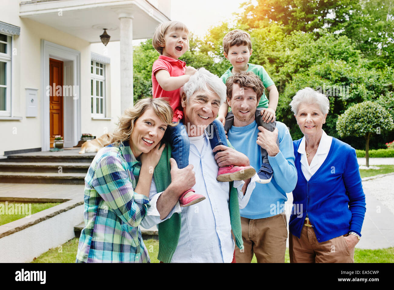 Germany, Hesse, Frankfurt, Three generations family in front of villa ...