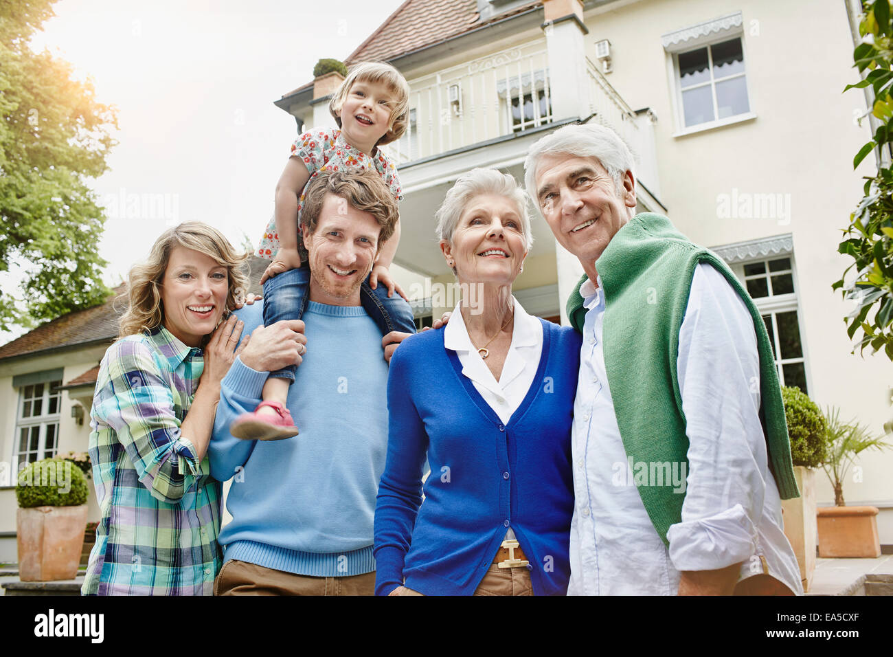 Germany, Hesse, Frankfurt, Three generations family in front of villa ...