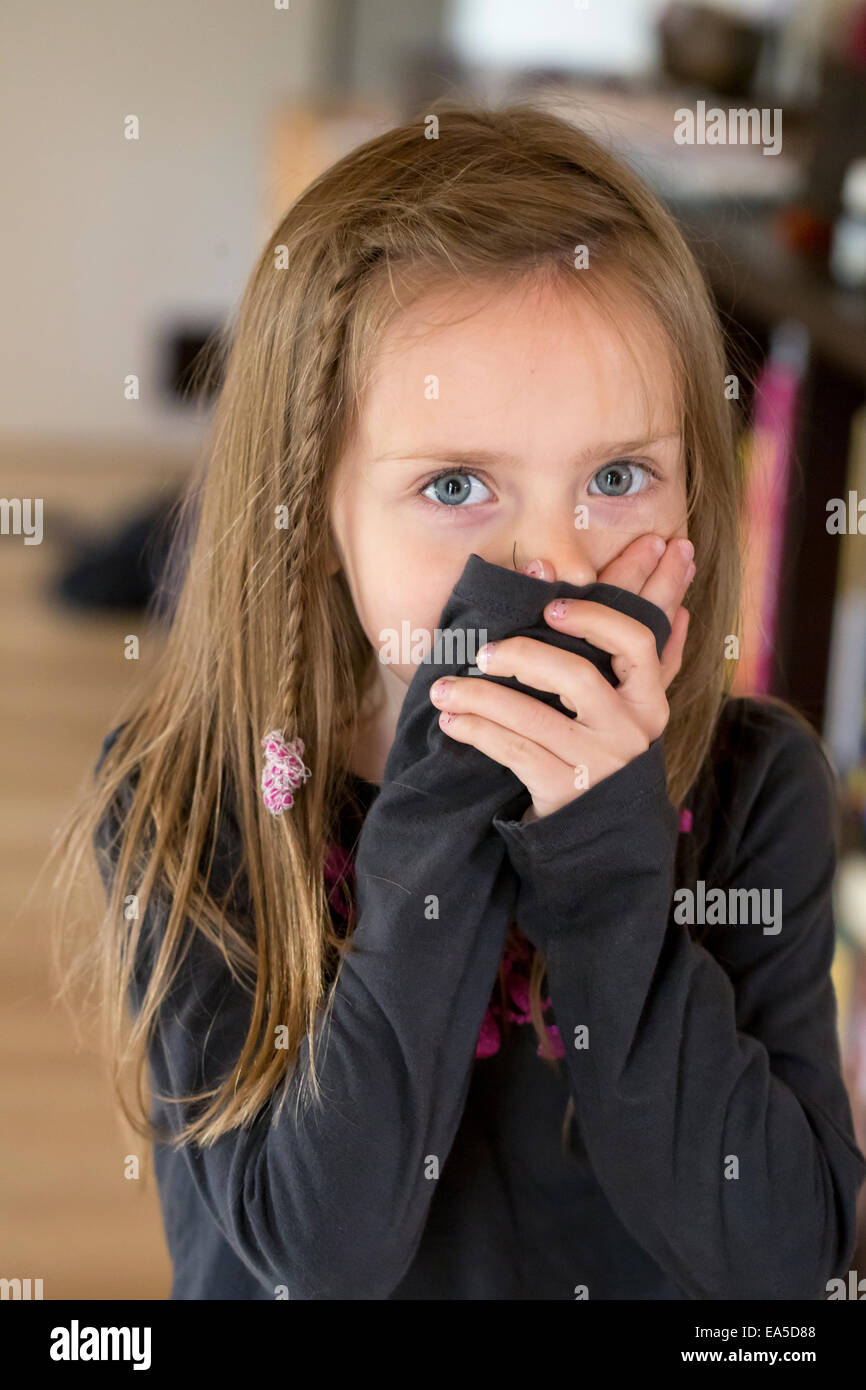Girl covering mouth with her hands Stock Photo - Alamy