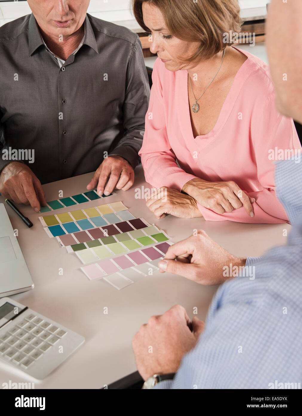 Three people discussing color sample Stock Photo - Alamy