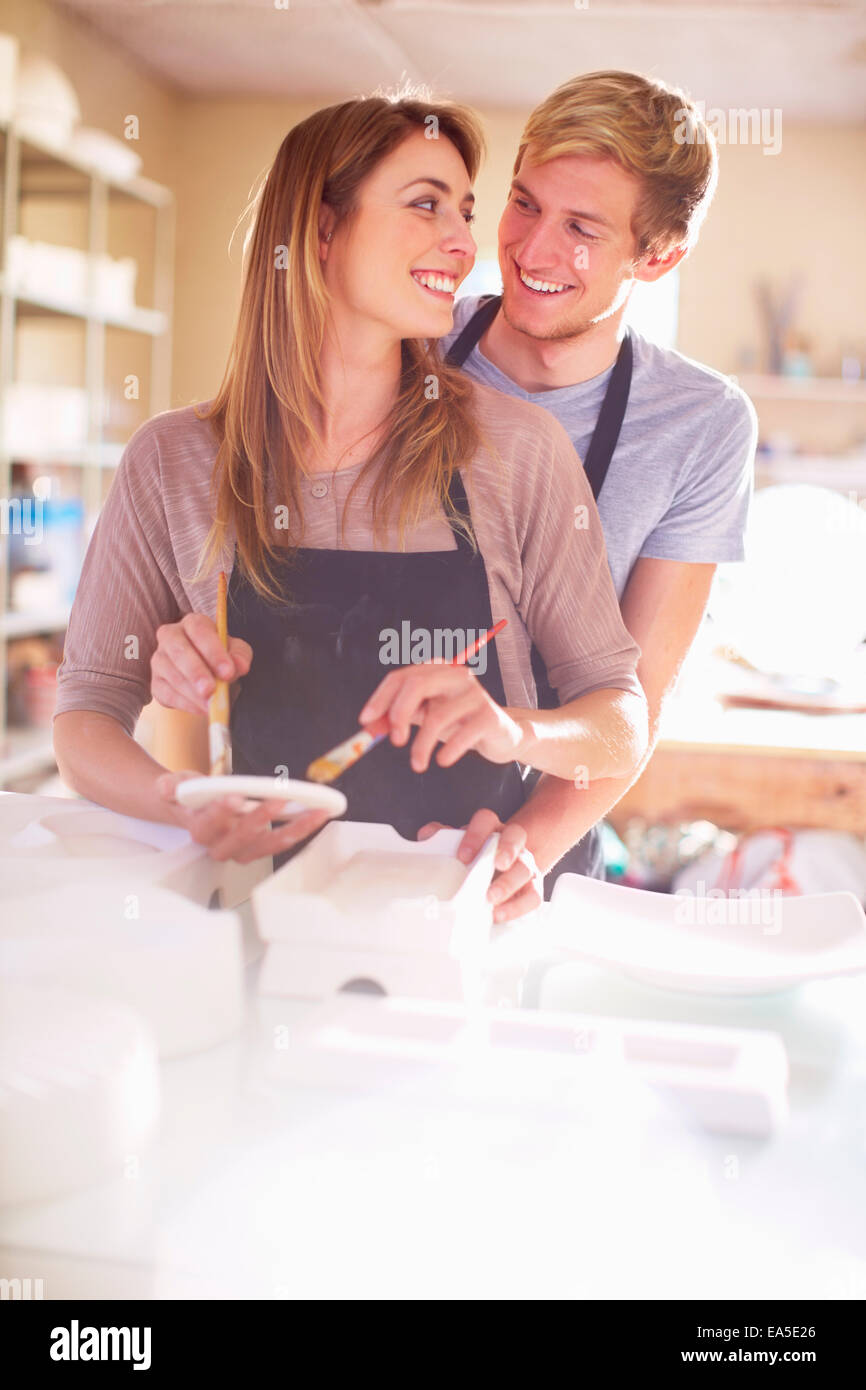 Happy couple working in a workshop Stock Photo - Alamy