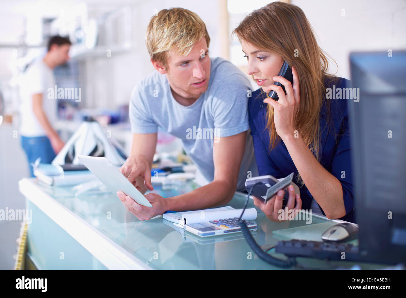 Young man and woman at shop counter Stock Photo - Alamy
