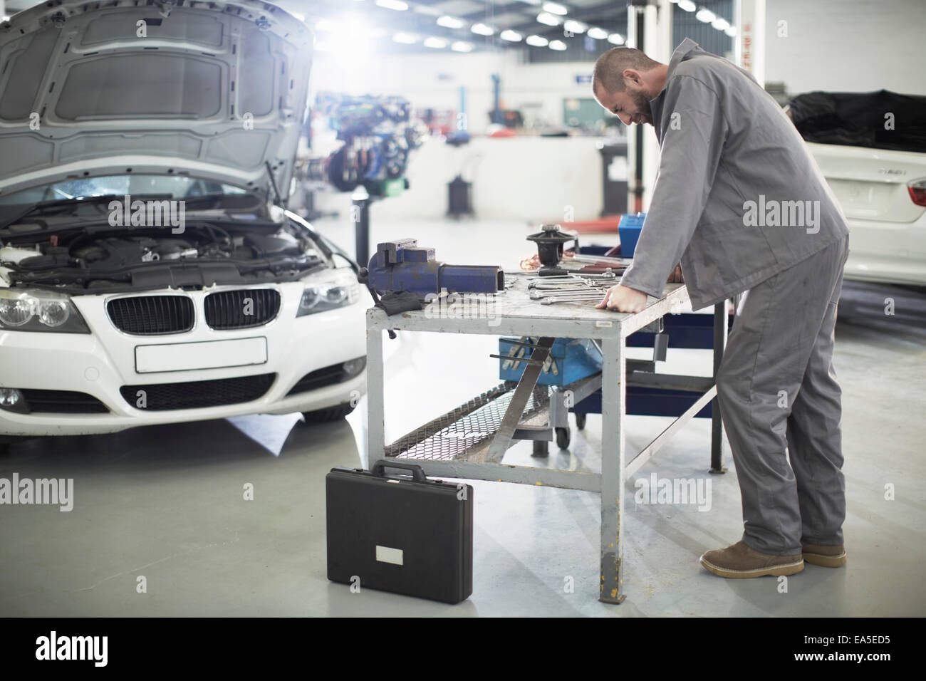 Stressed car mechanic in repair garage Stock Photo - Alamy