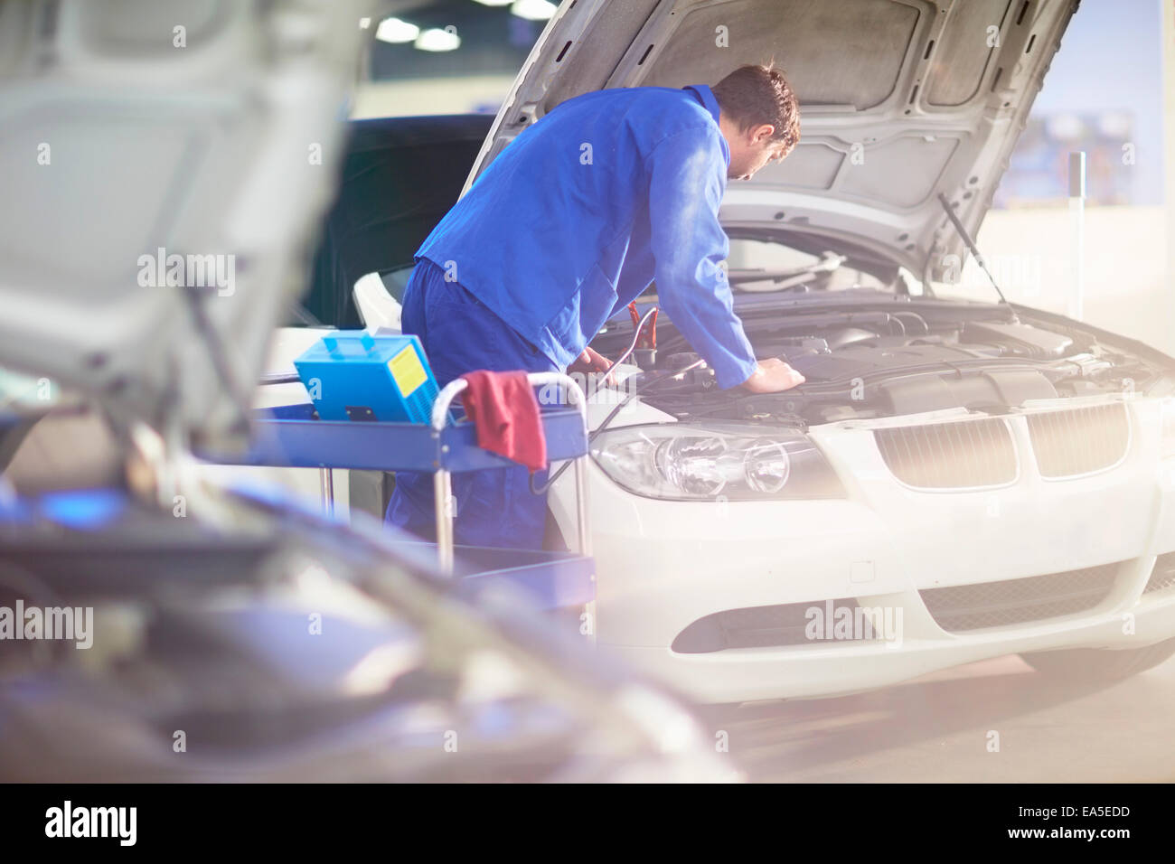 Car mechanic at work in repair garage Stock Photo - Alamy
