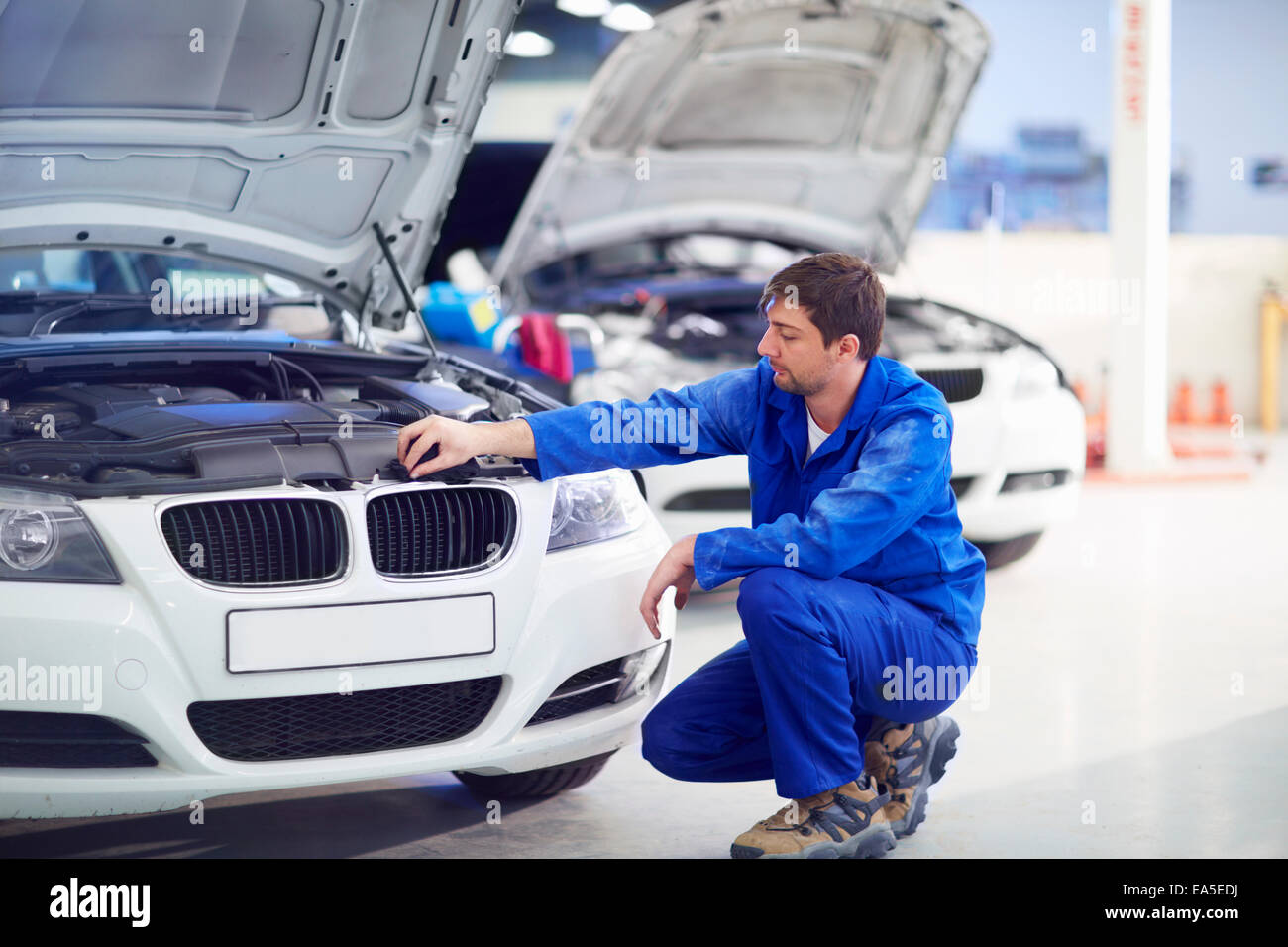Car mechanic at work in repair garage Stock Photo - Alamy