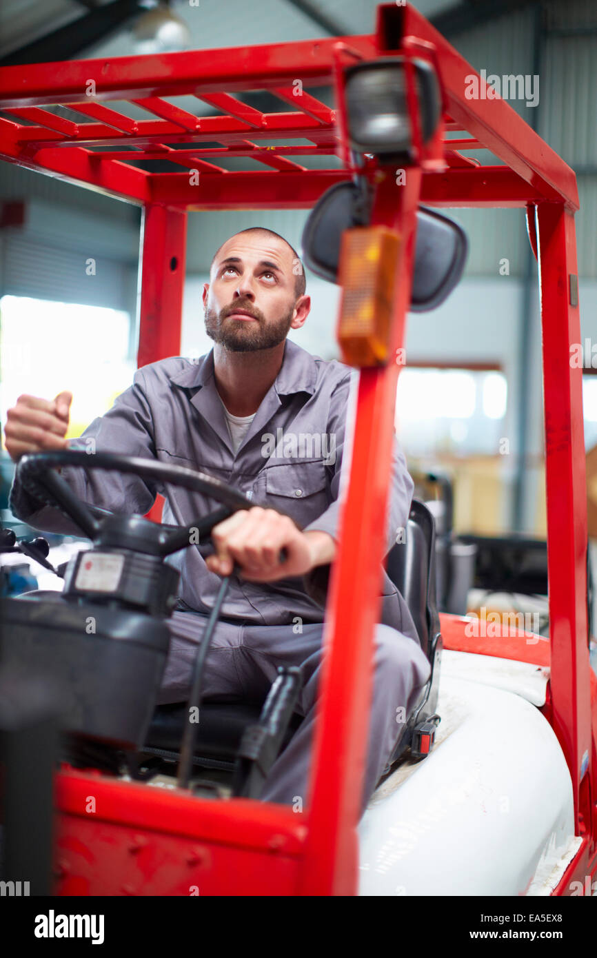 Worker on forklift in factory Stock Photo - Alamy