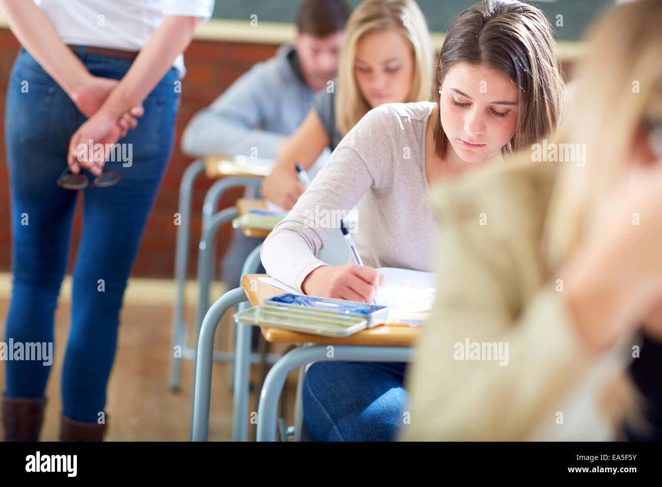 Students in classroom having an exam Stock Photo - Alamy