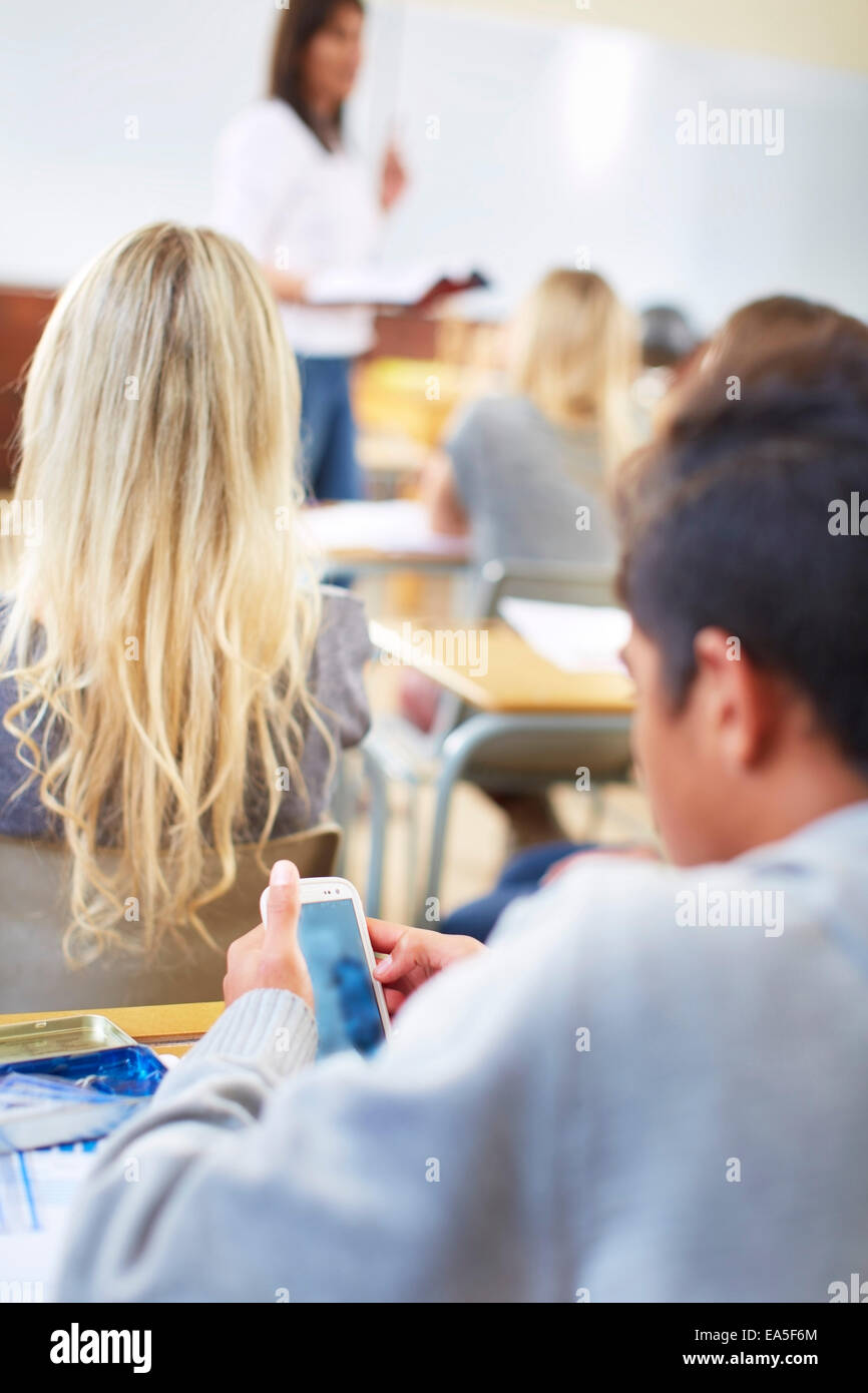 Student using cell phone in classroom Stock Photo - Alamy