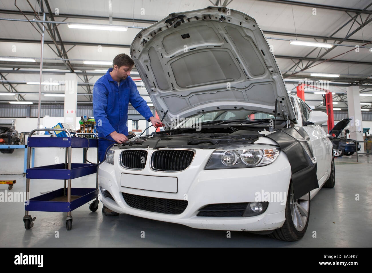 Car mechanic at work in repair garage Stock Photo - Alamy