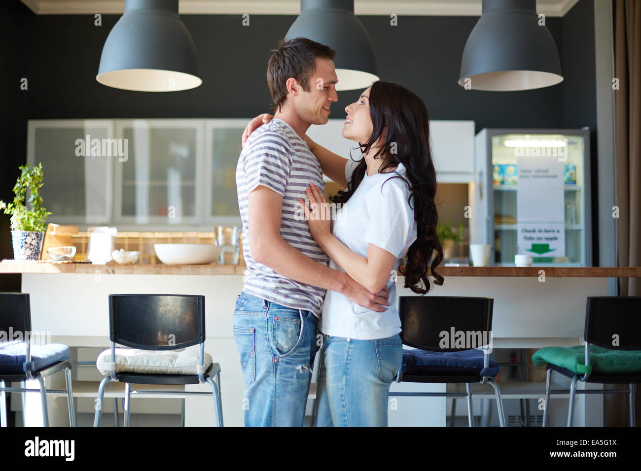 Amorous man and woman looking at one another with smiles Stock Photo ...