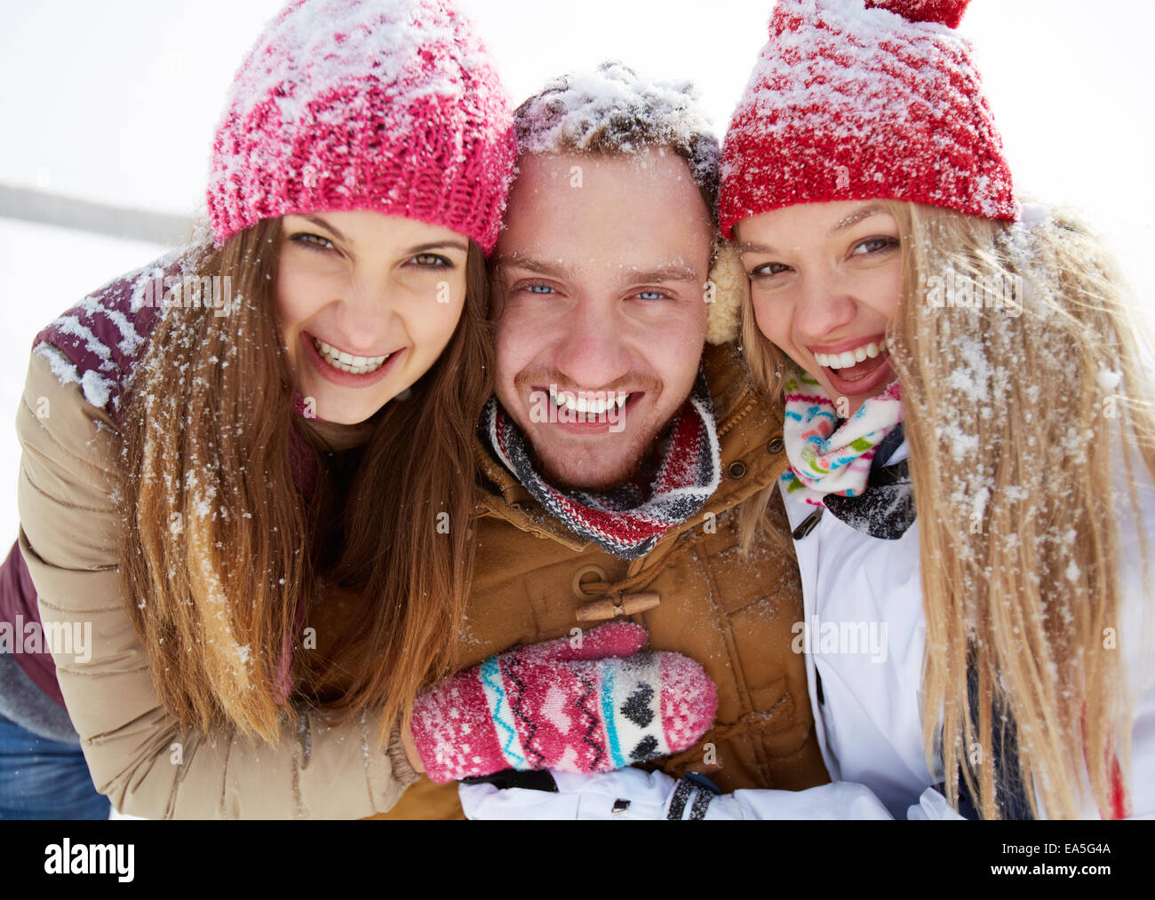 Joyful friends looking at camera and laughing Stock Photo - Alamy